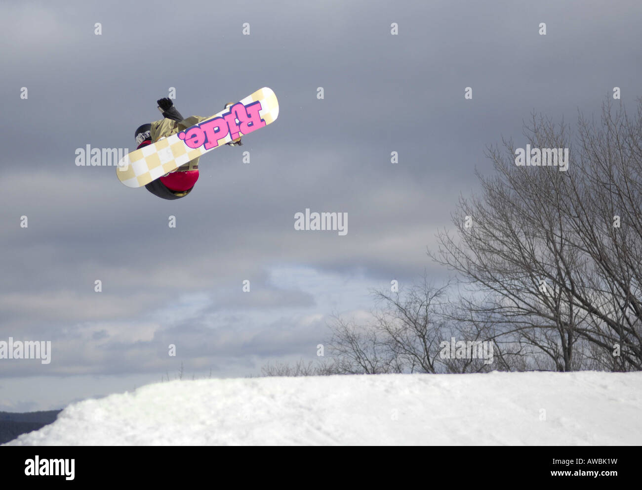 A young male snowboarder performs a freestyle mid air stunt Stock Photo ...