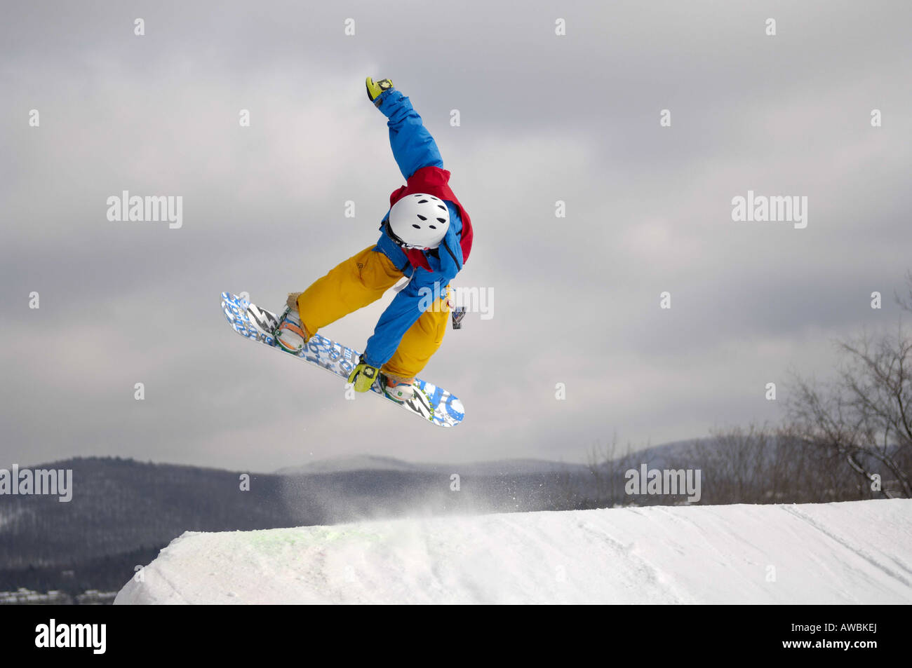 A young male snowboarder performs a freestyle mid air stunt Stock Photo ...