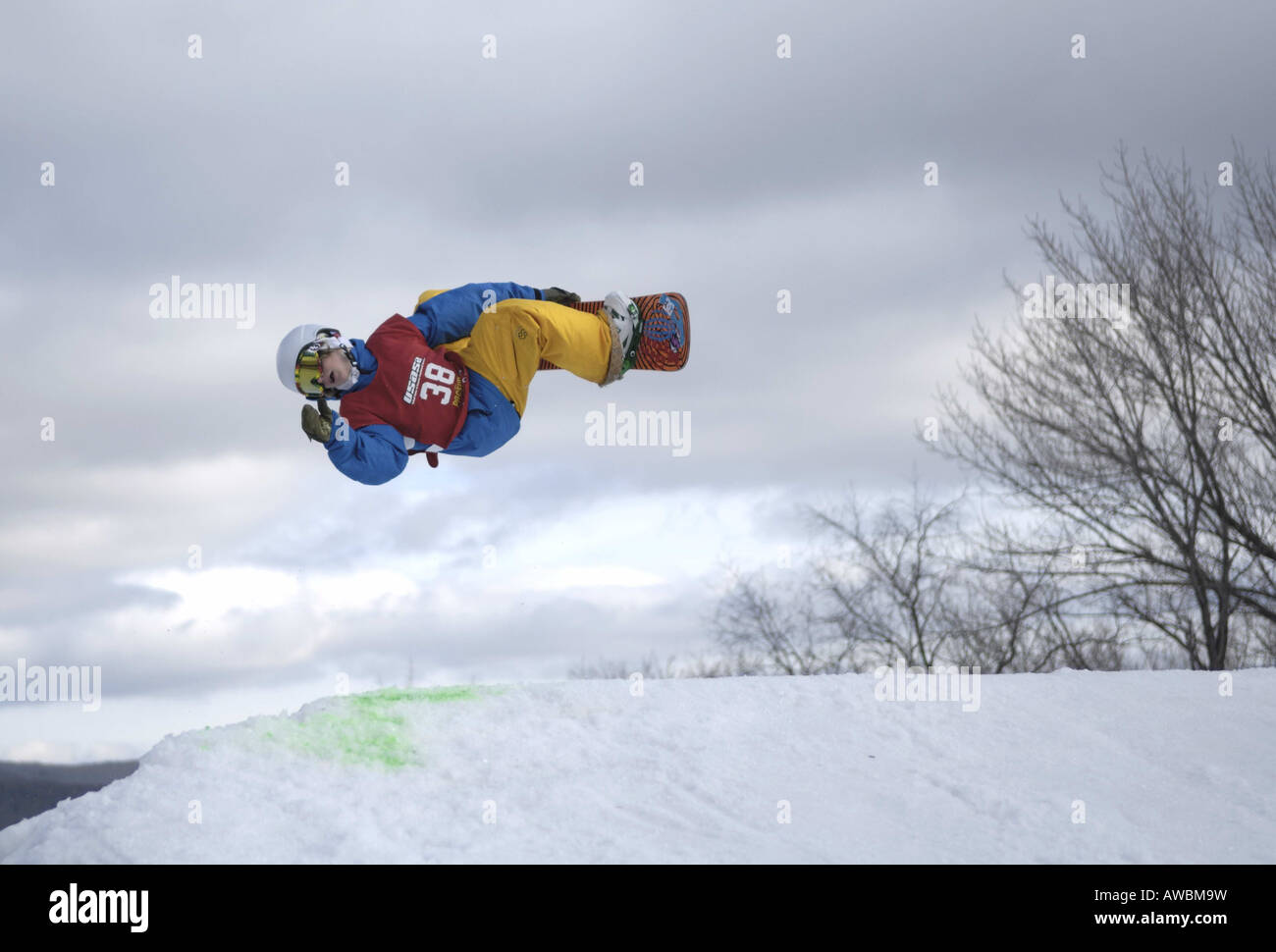 A young male snowboarder performs a freestyle mid air stunt Stock Photo ...