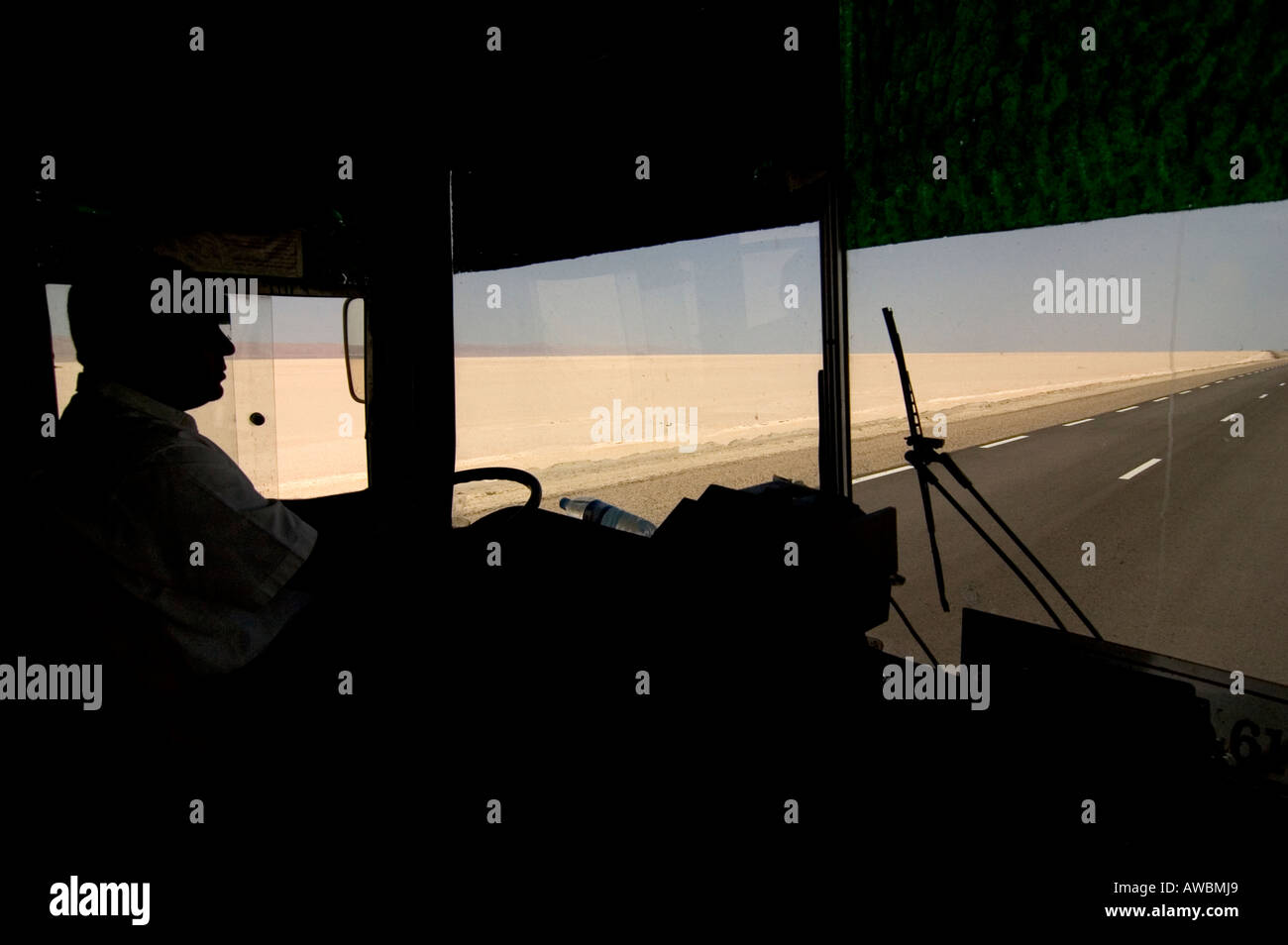Man driving a public bus on a desert Sahara road, photo taken in South ...