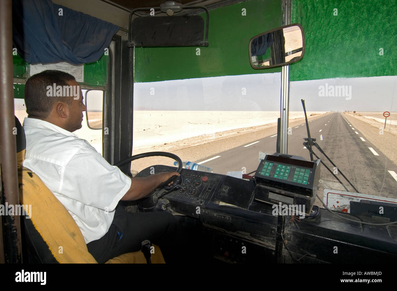 Man driving a public bus on a desert Sahara road, photo taken in South ...