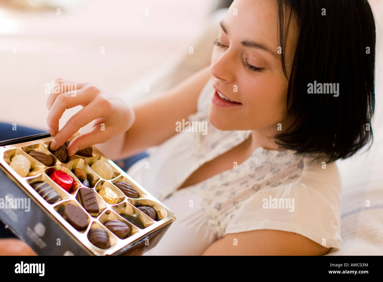 Woman with box of chocolates Stock Photo - Alamy