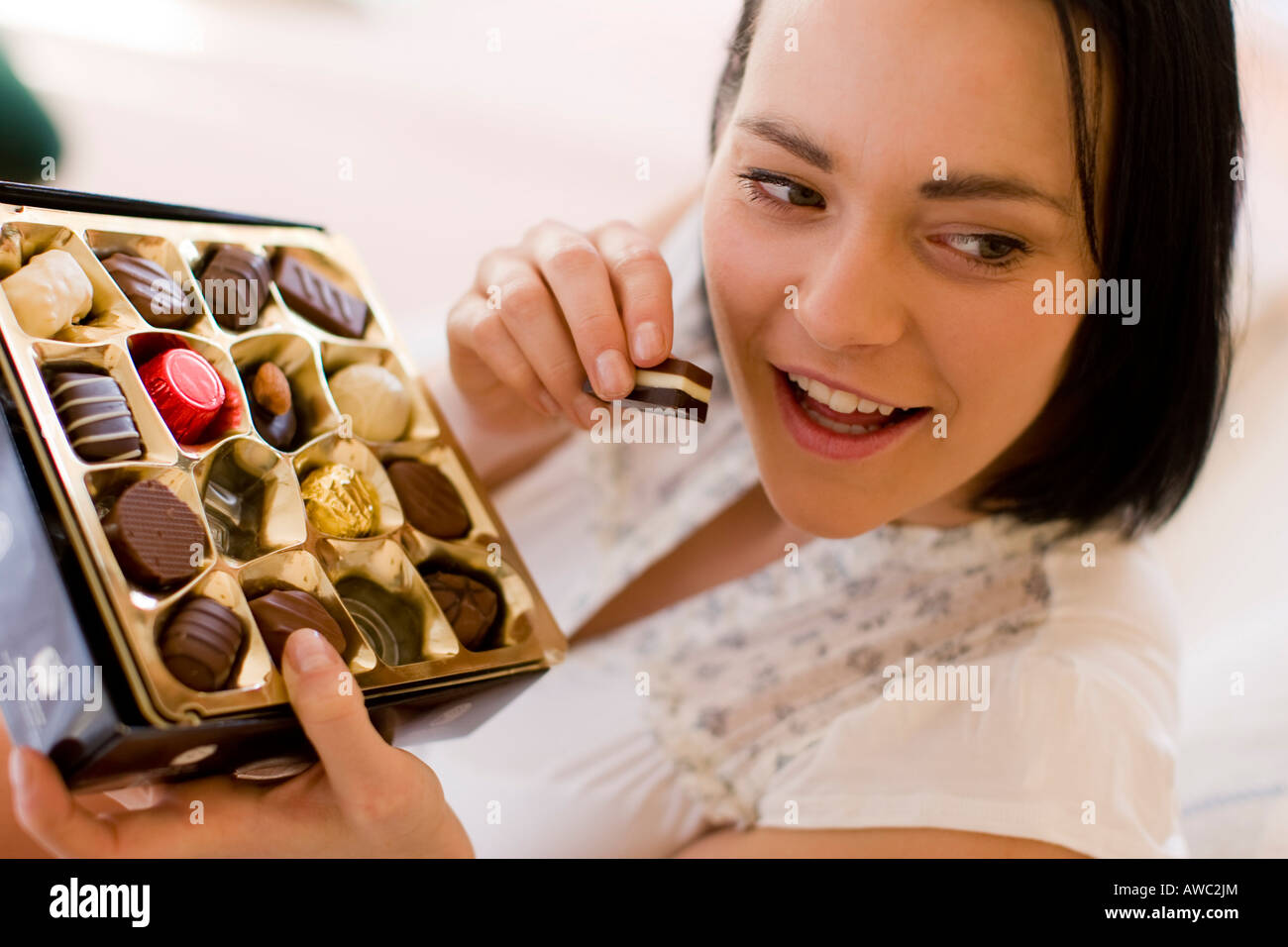 Woman with box of chocolates Stock Photo - Alamy