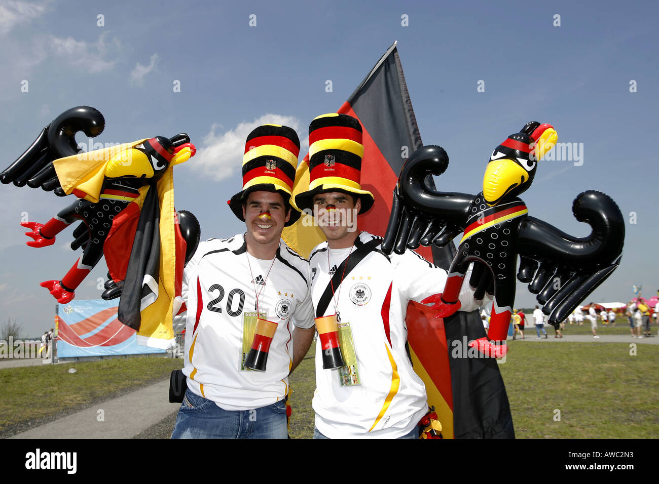 Two male German fans wearing hats hold up inflatable eagles on the ...