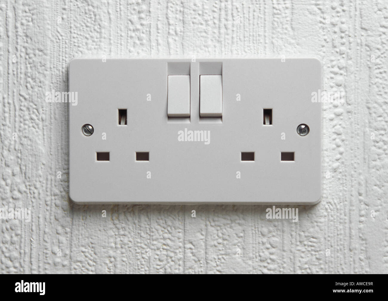 White plastic double electrical plug socket on white wall Stock Photo ...