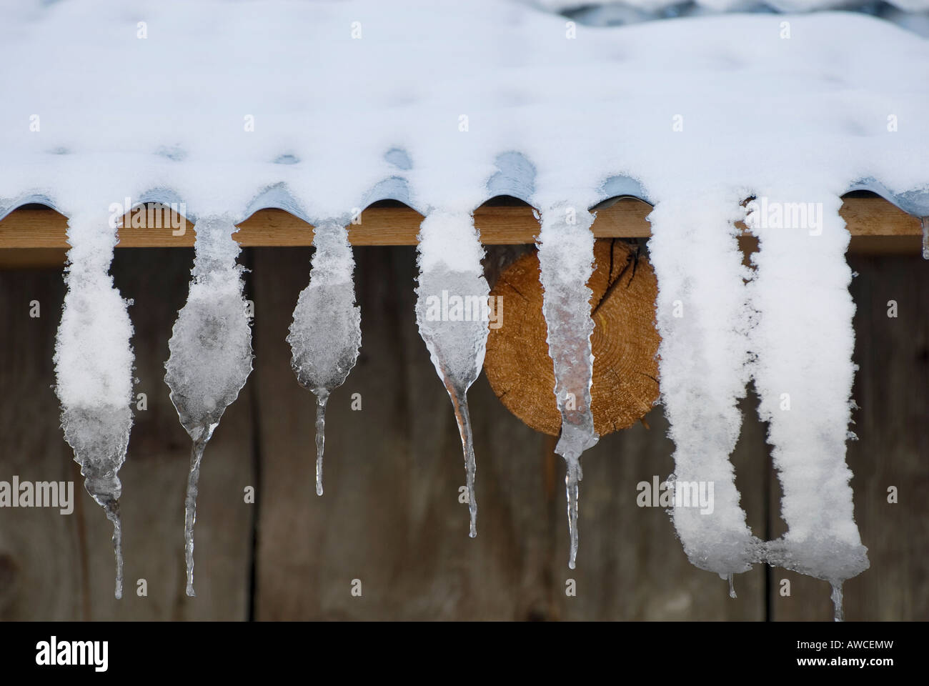 odd shaped icicles on chalet roof, chatel, france Stock Photo - Alamy