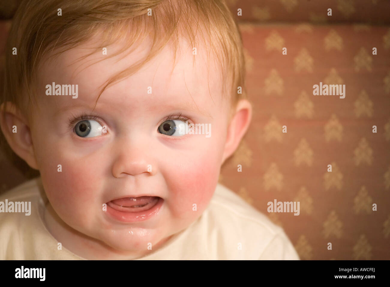 Head of baby girl looking to her right with concerned expression Stock ...