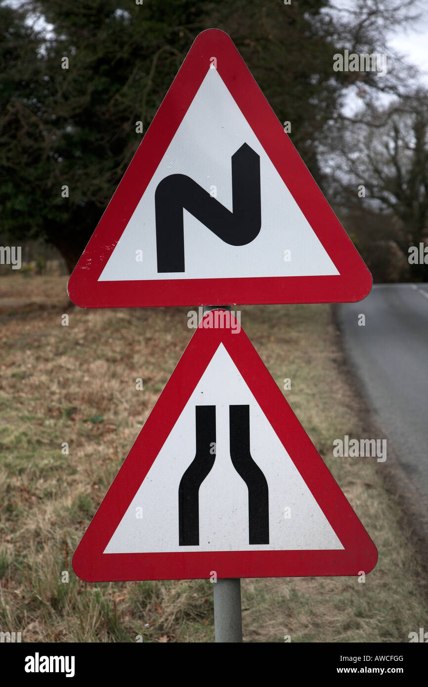 Road signs for road narrowing and bends ahead Stock Photo - Alamy