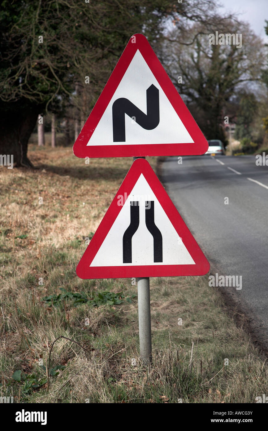 Road signs for road narrowing and bends ahead Stock Photo - Alamy