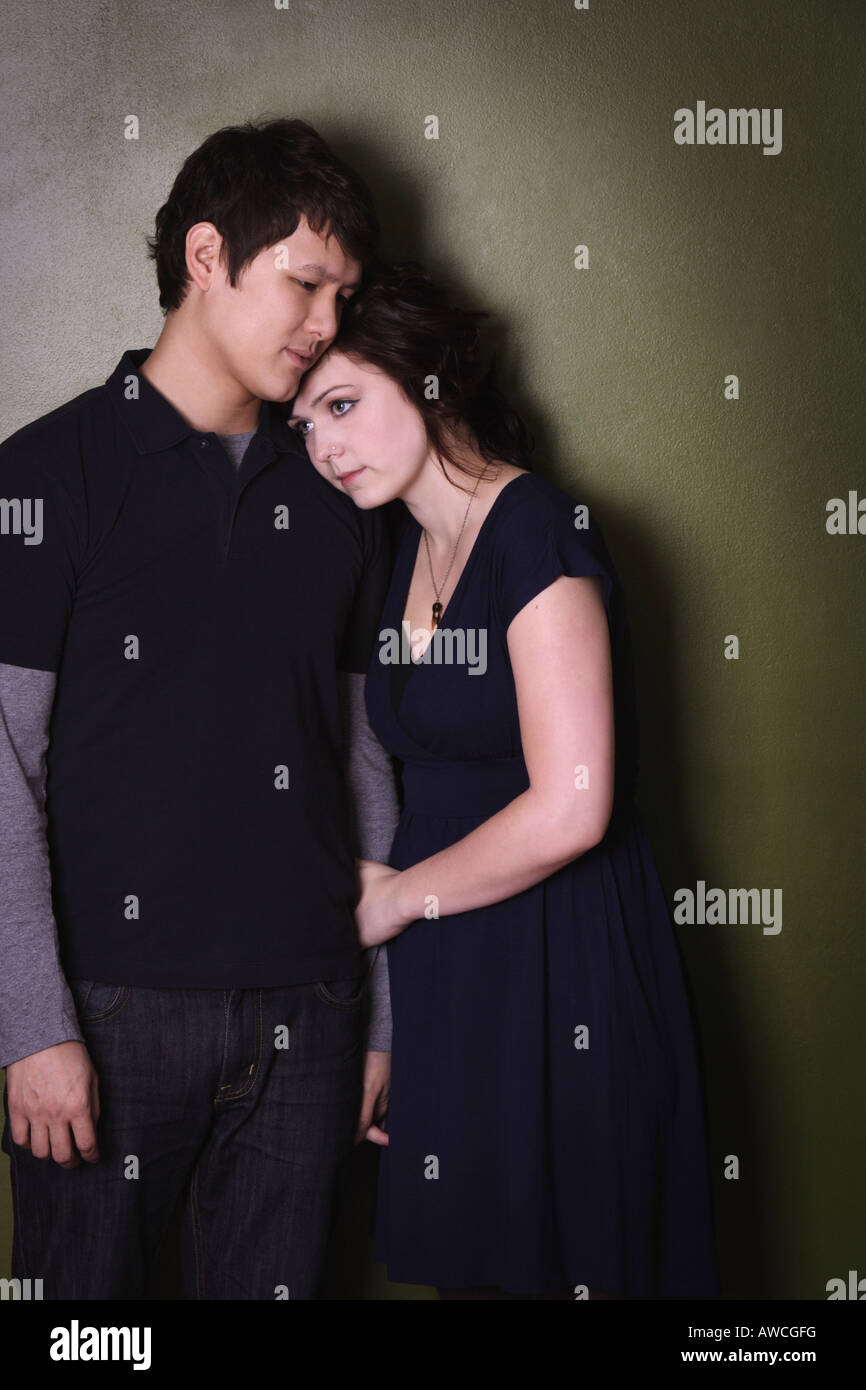 Couple leaning on one another Stock Photo - Alamy