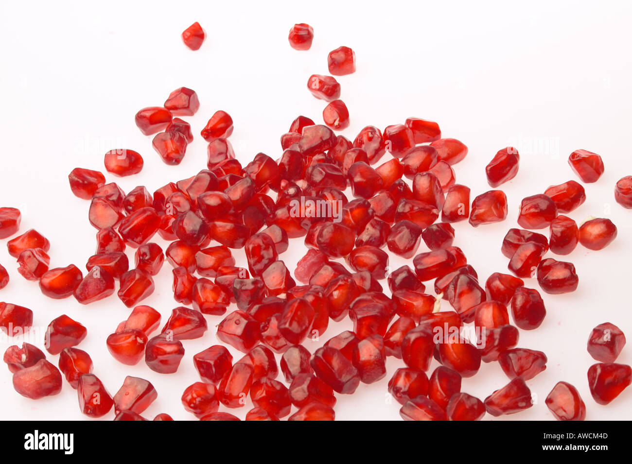Pomegranate fruit red seeds sprinkled on white background Stock Photo ...