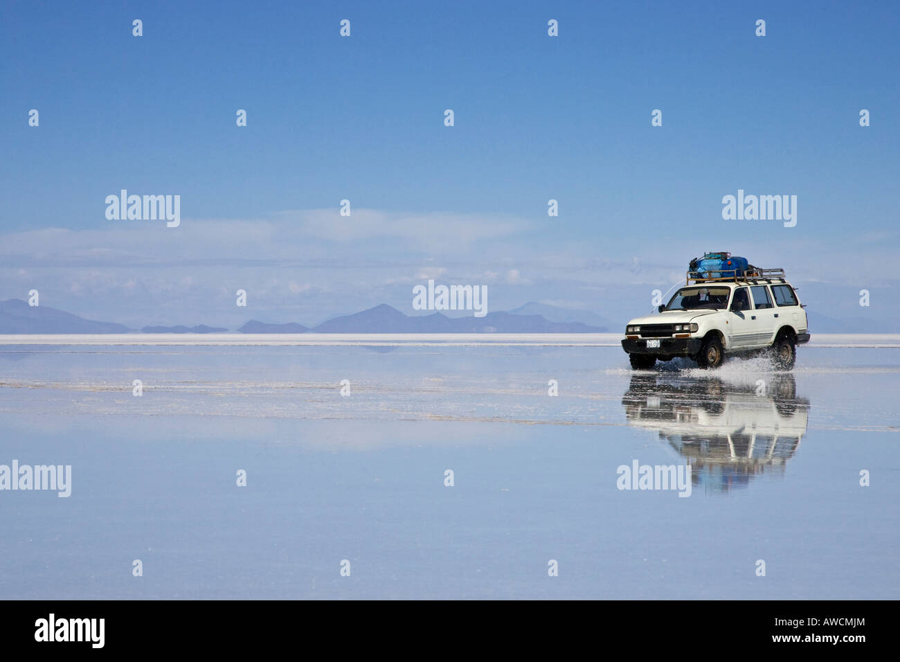 Driving car on the salt lake Salar de Uyuni, Altiplano, Bolivia, South ...