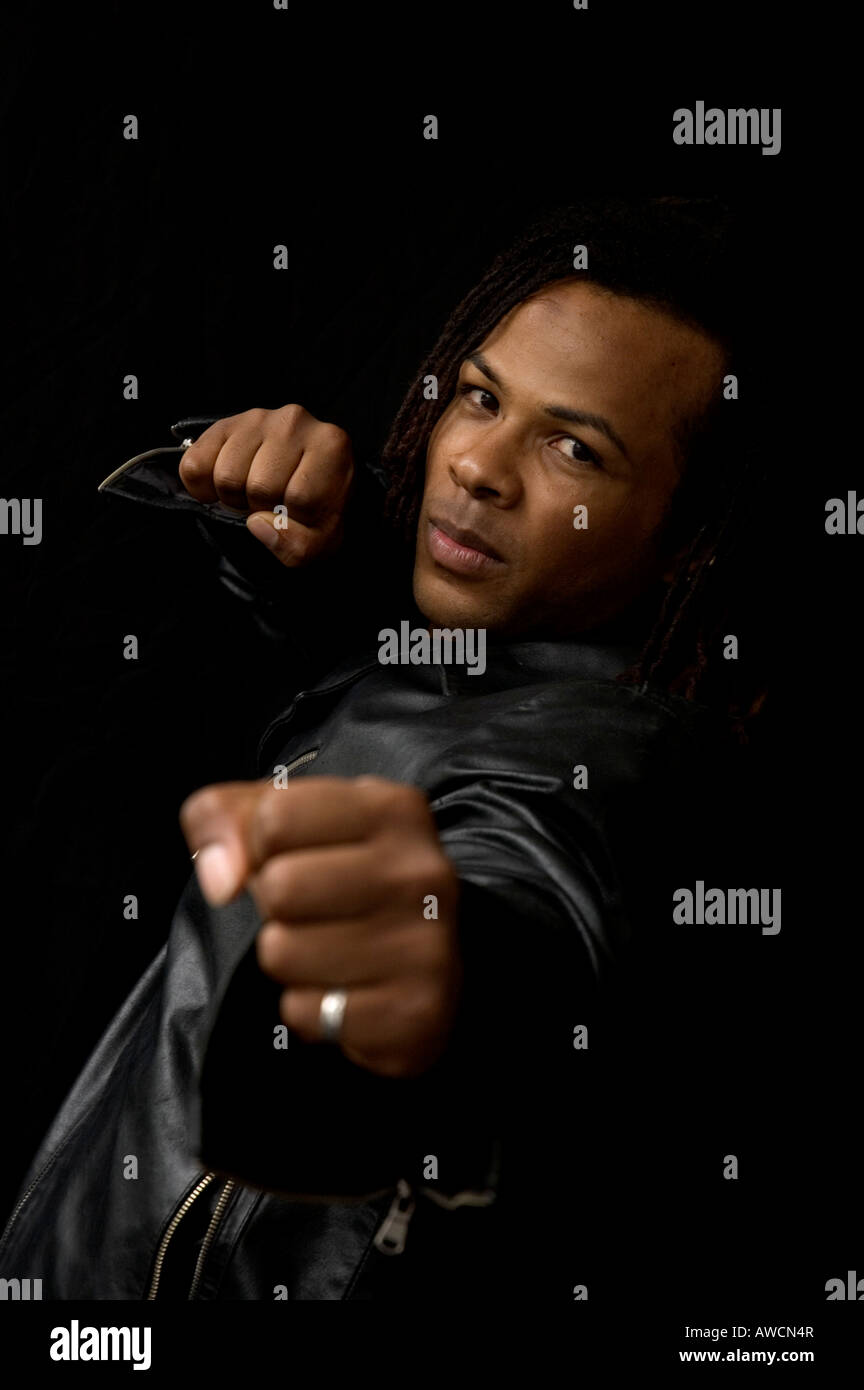 Young black man with his hands balled into fists Stock Photo - Alamy