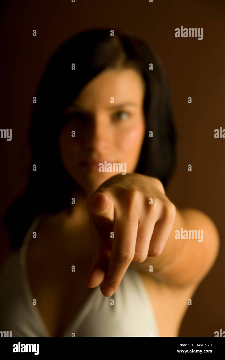 Young dark-haired woman stretching out her finger Stock Photo - Alamy