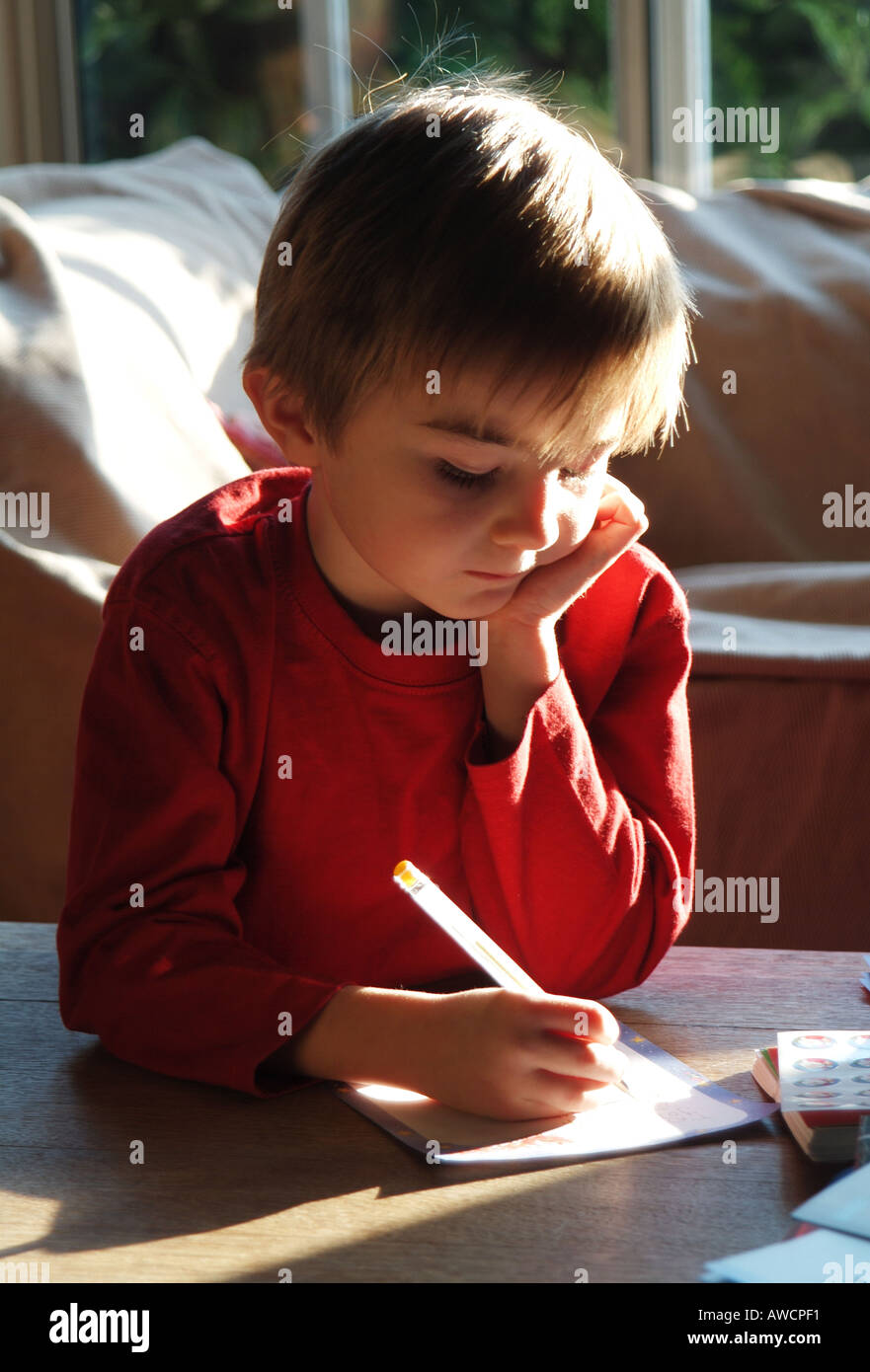 young boy doing his homework Stock Photo - Alamy