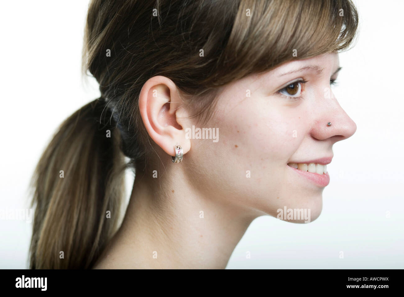 Portrait of a young woman with ponytail, profile Stock Photo - Alamy