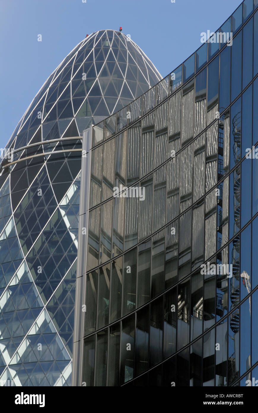UK The Swiss RE modern building and reflection of the Lloyds HQ in the ...
