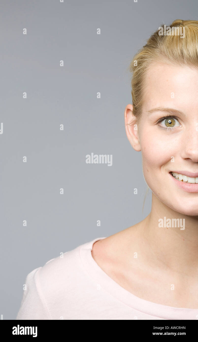 Truncated portrait of a laughing young blonde woman (half of the face Stock Photo - Alamy
