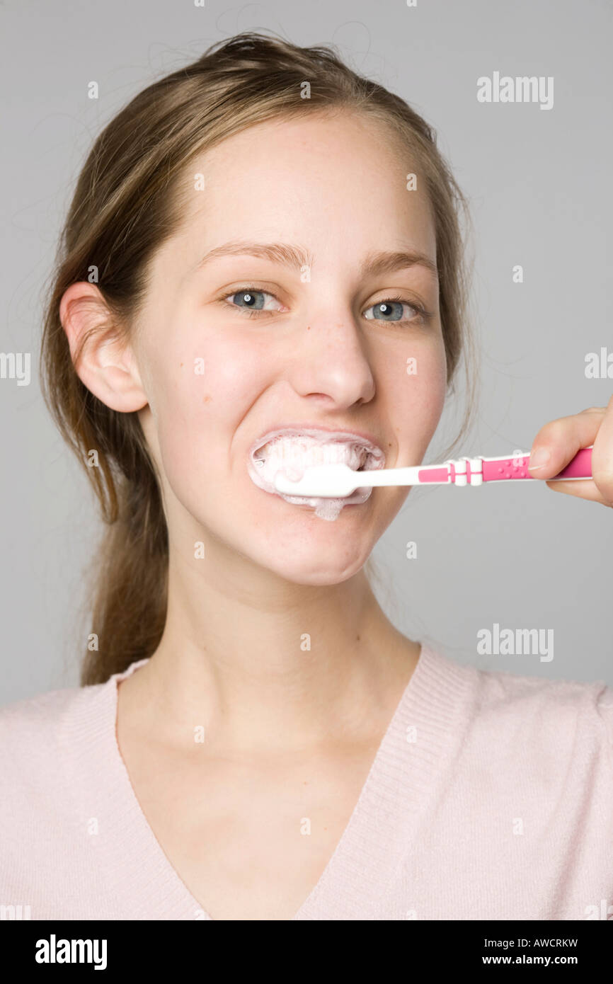 Young woman brushing her teeth Stock Photo - Alamy