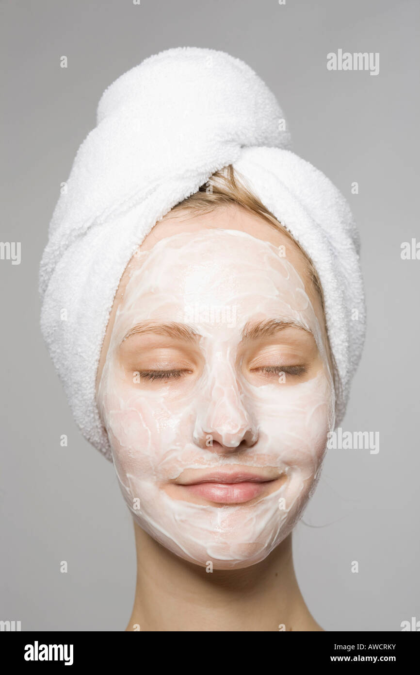 Young woman with face mask and white towel Stock Photo - Alamy