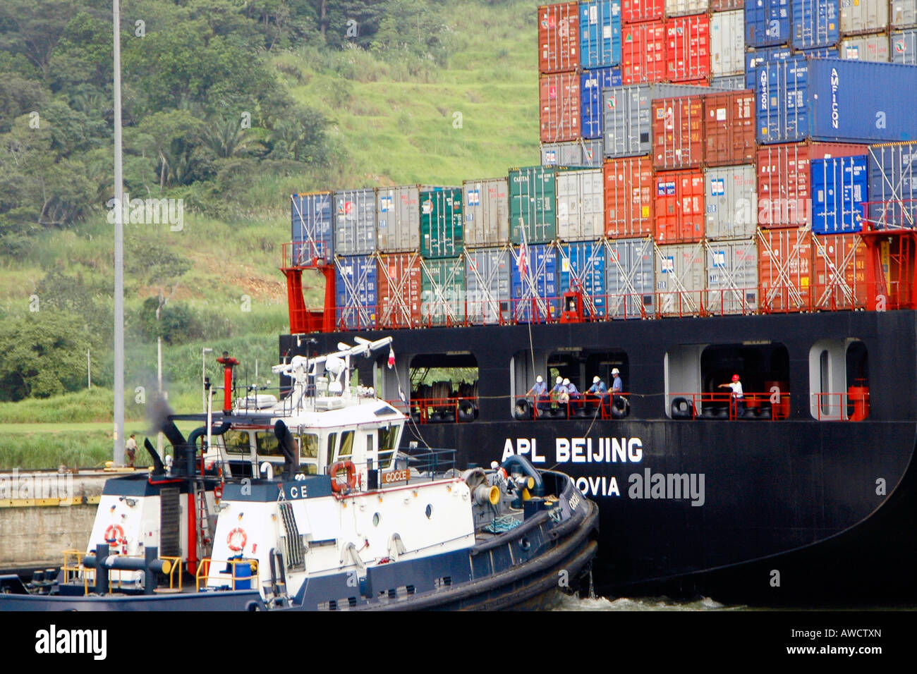 Tugboat positioning container ship in the Panama Canal, Panama Stock ...