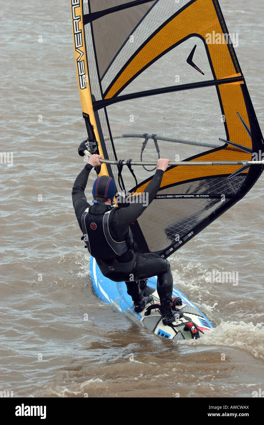Windsurfer with a yellow sail racing over the waves Stock Photo - Alamy