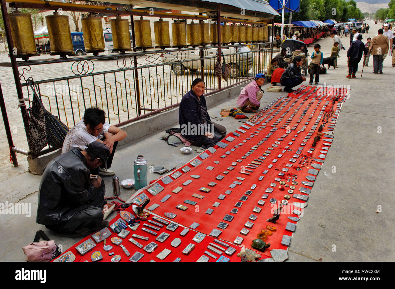 Souvenir dealers, sitting in front of prayer mills, entrance of Palcho ...