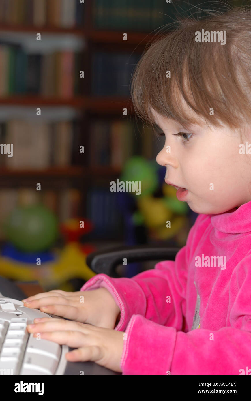 The little girl for studying keyboard of a computer Stock Photo - Alamy