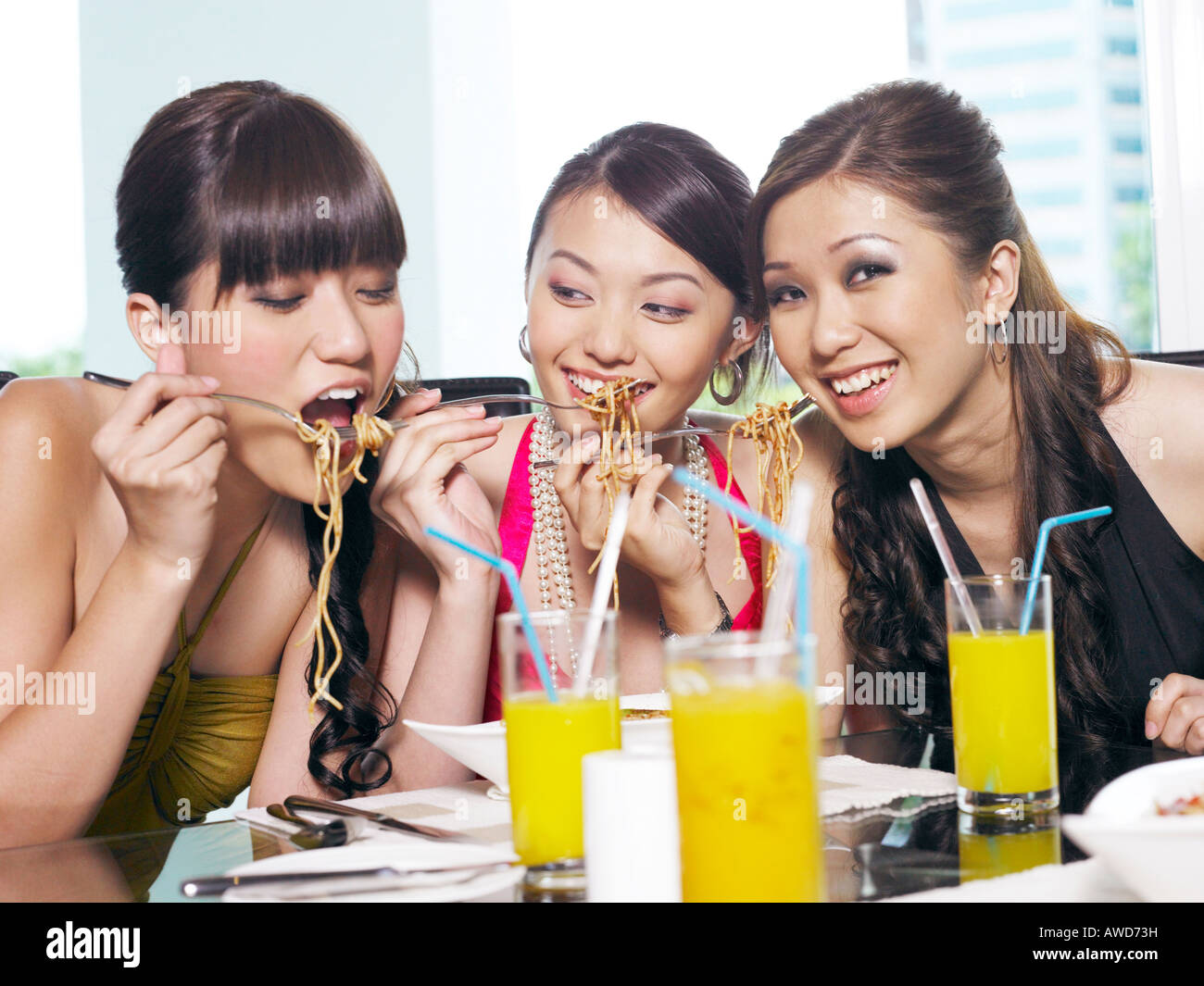three young women dining in the restaurant Stock Photo - Alamy