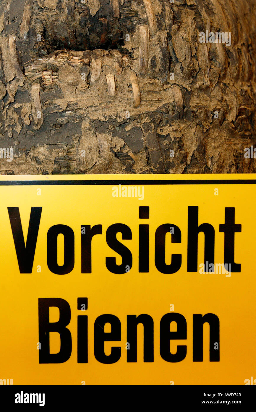 Caution bees - Sign in front of a beehive Stock Photo - Alamy