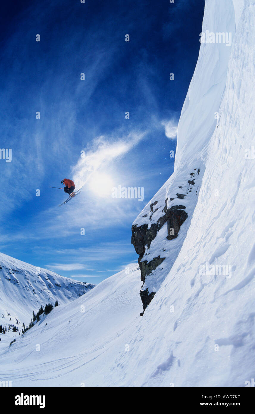 Skier jumping from mountain ledge Stock Photo - Alamy