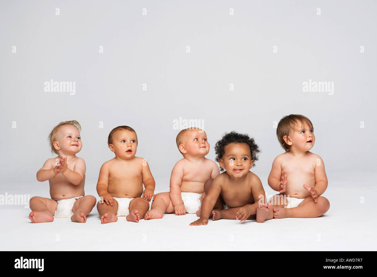 Five babies, one looking in different direction Stock Photo - Alamy