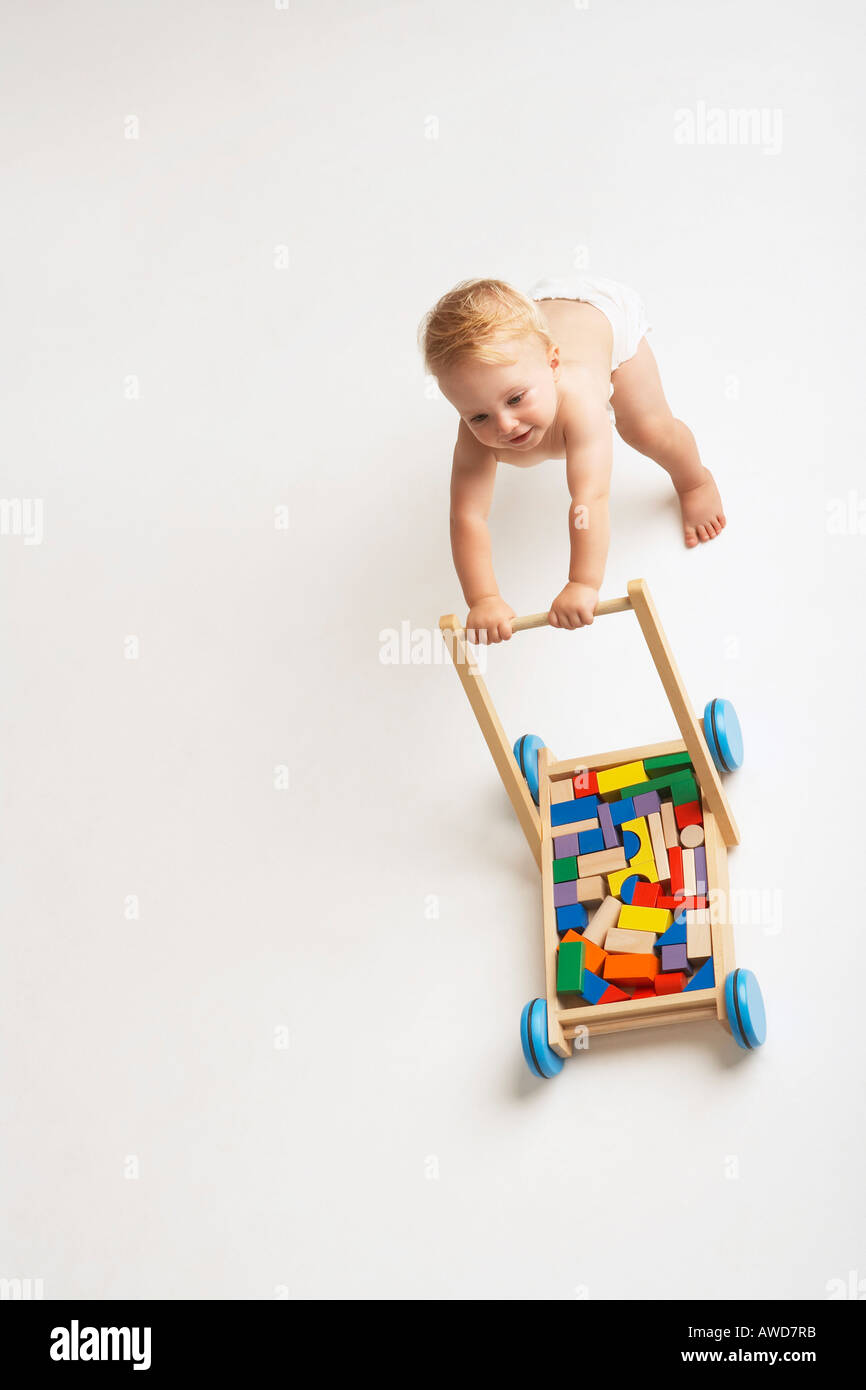 Baby Pushing Cart of Blocks Stock Photo - Alamy