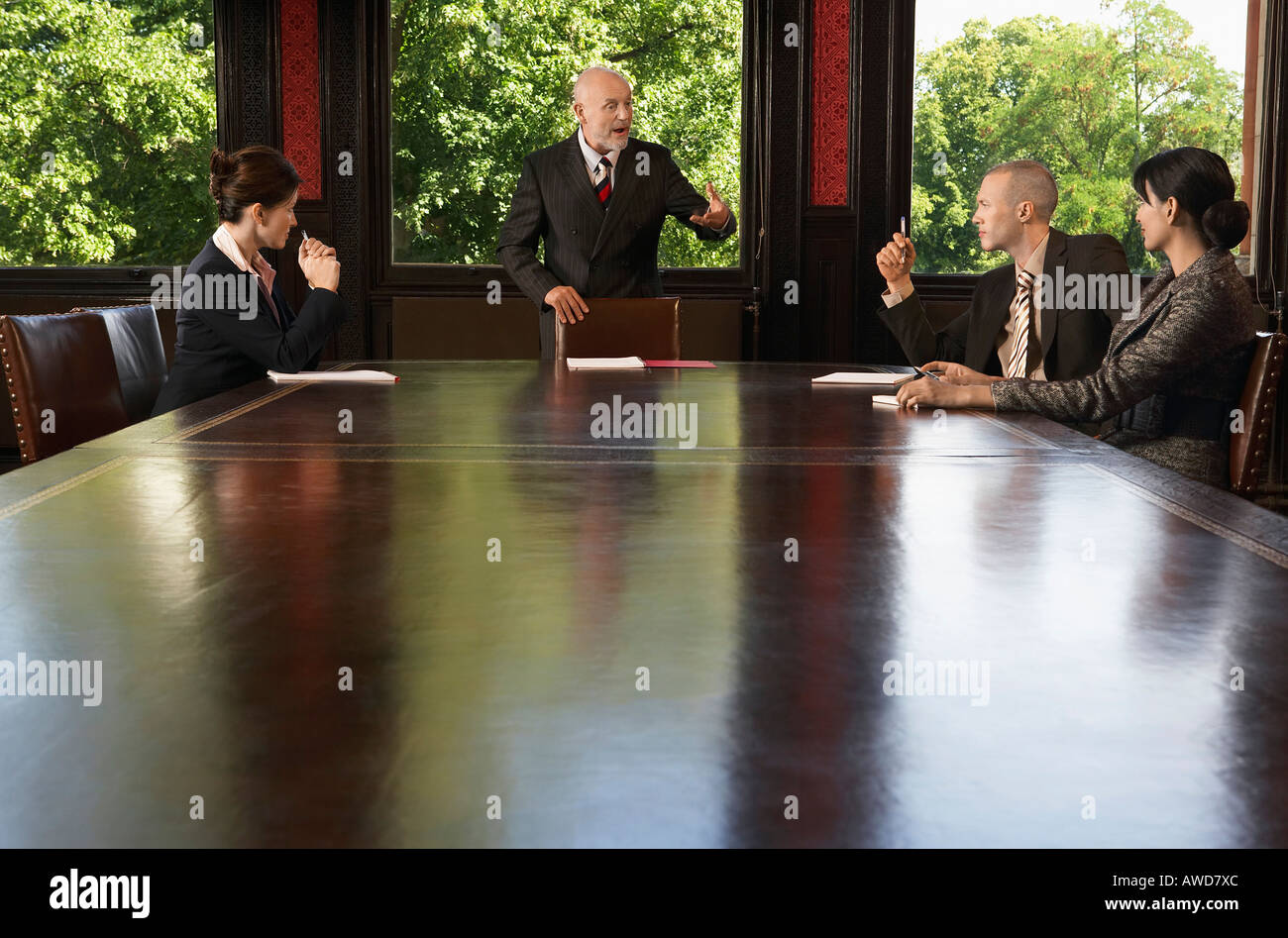 Businessman sitting around boardroom table hi-res stock photography and ...