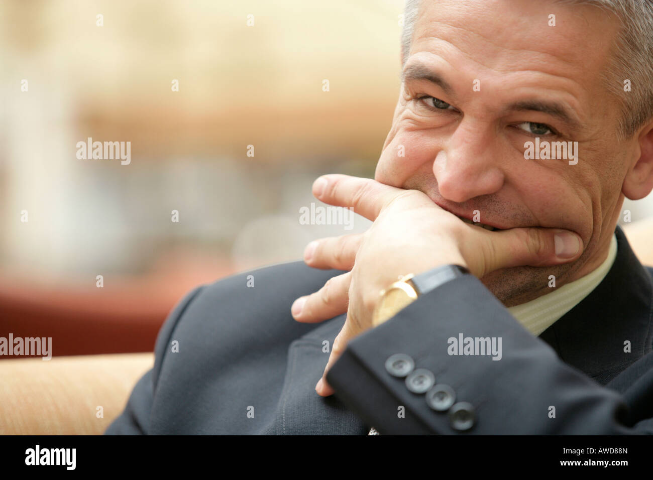 Businessman biting his hand Stock Photo - Alamy
