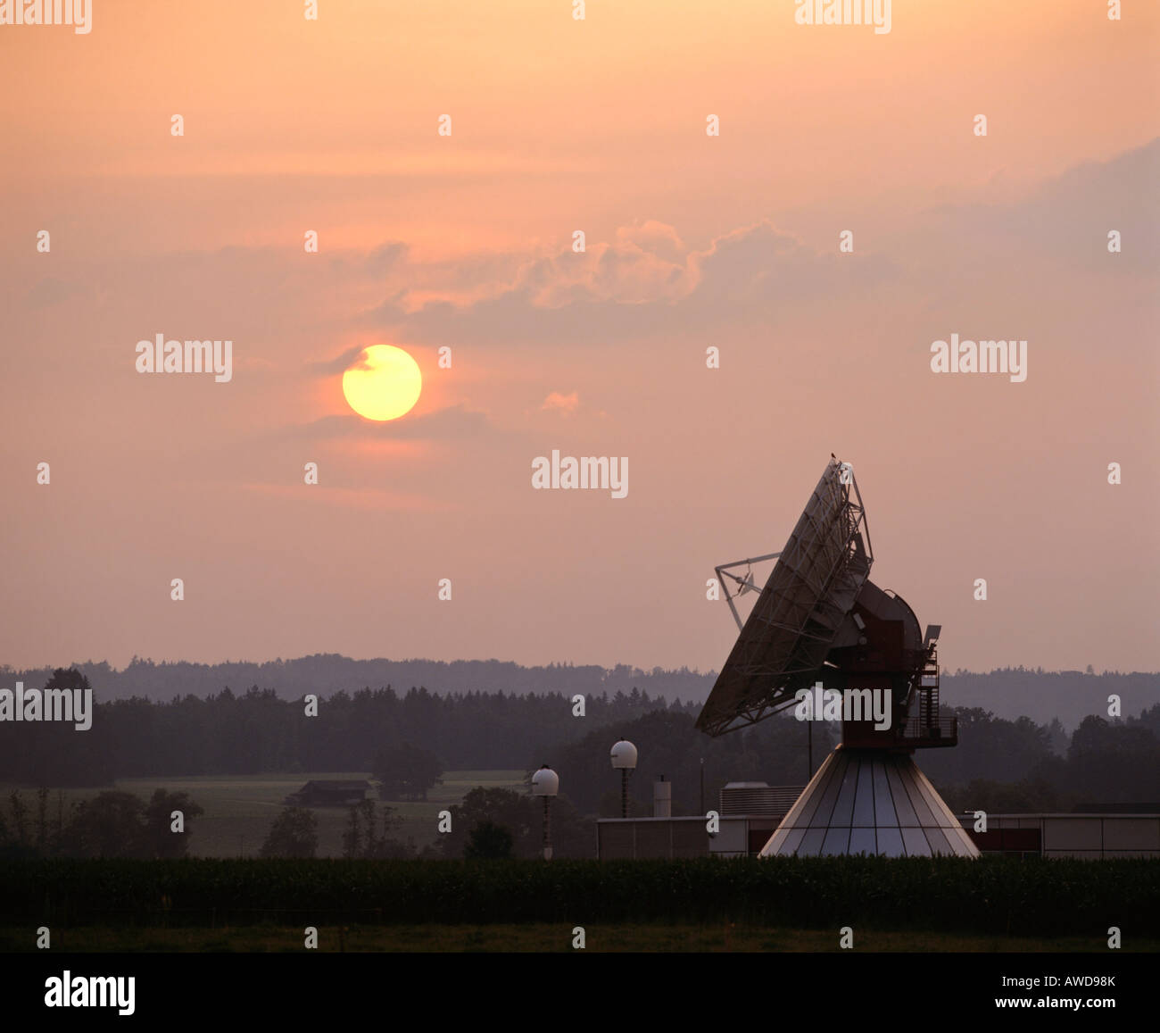 Sun at dusk, antennas of the ground communication station Raisting ...