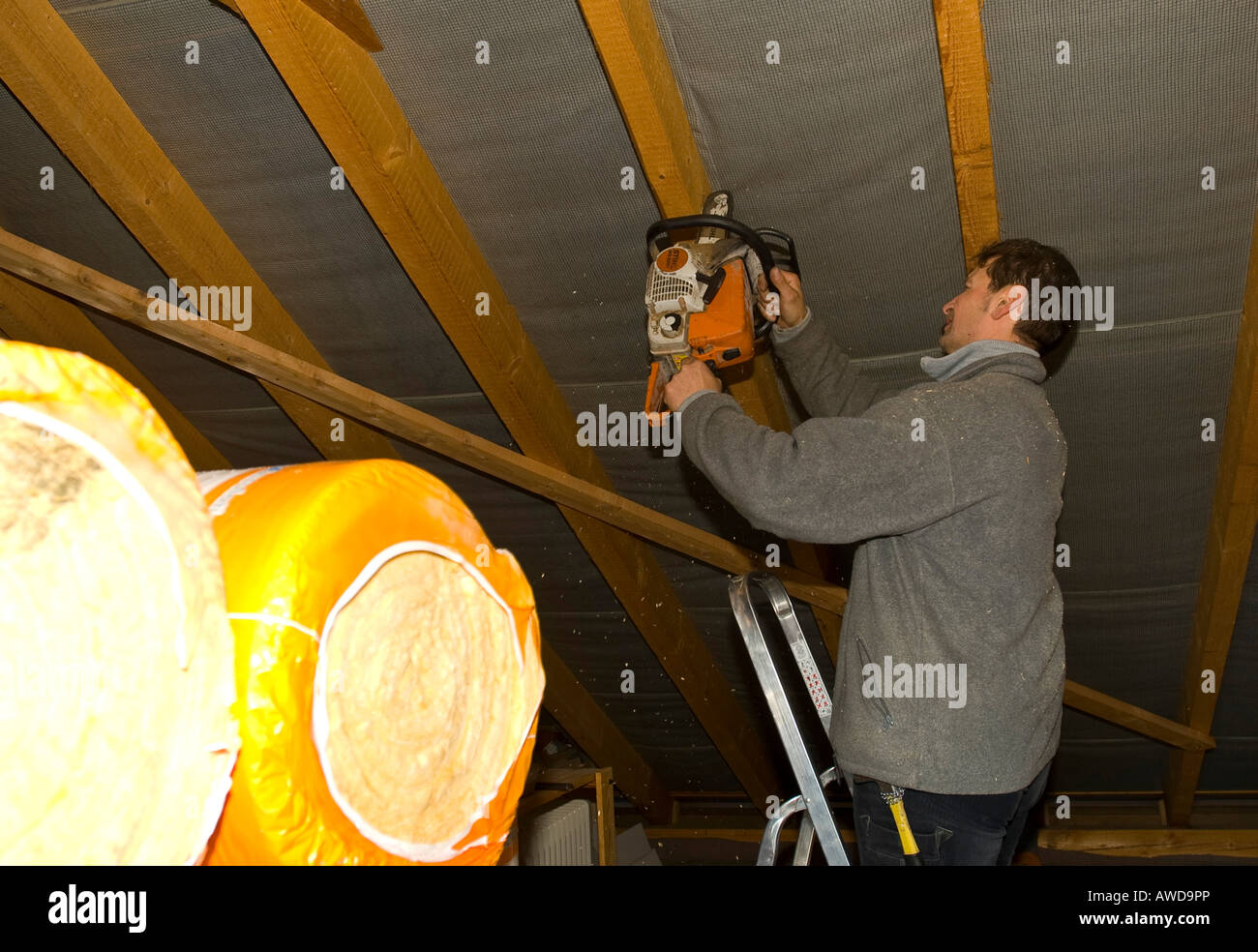 Carpenter working with chainsaw at the roof truss Stock Photo - Alamy