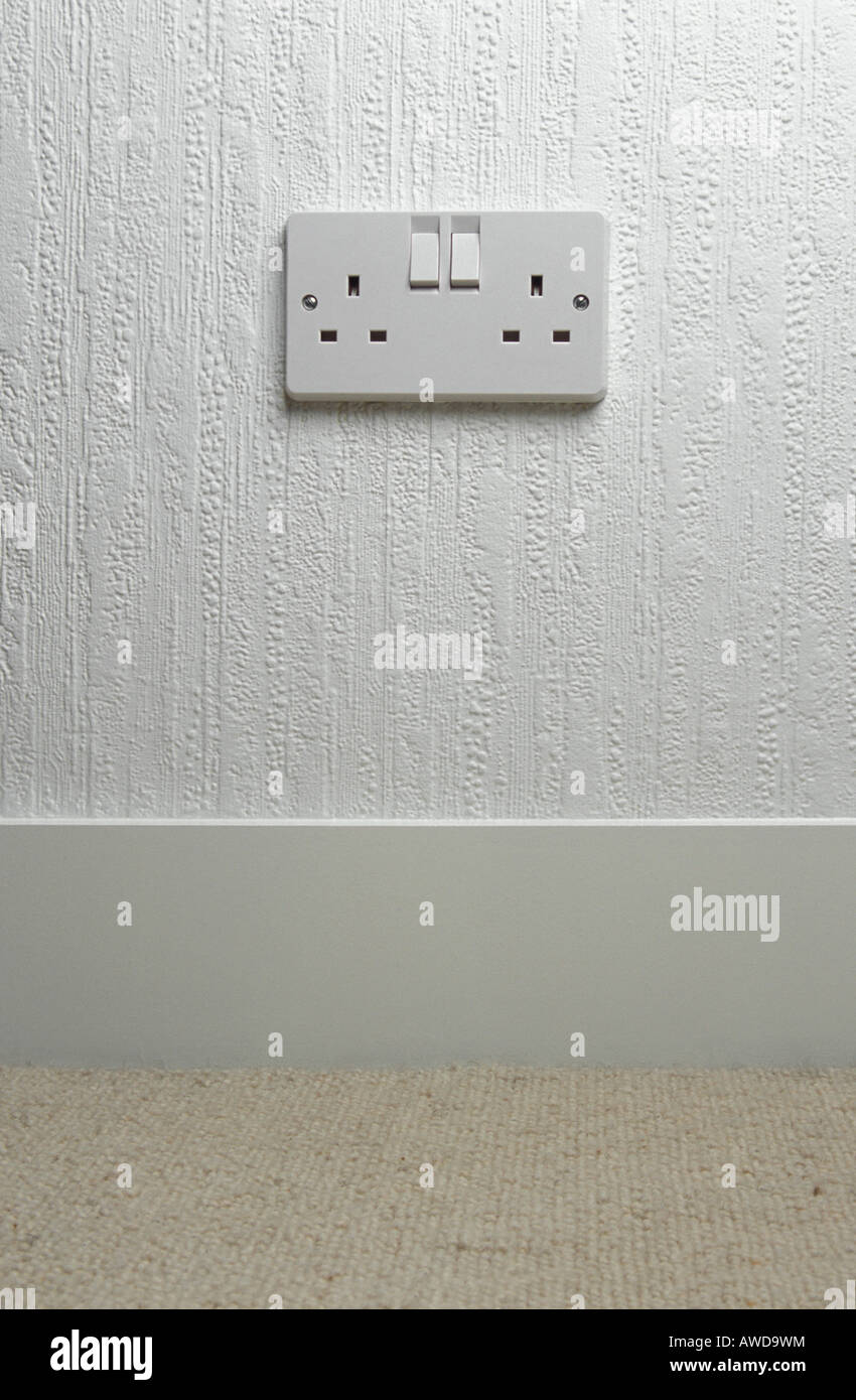 White plastic double electrical plug socket on white wall Stock Photo ...