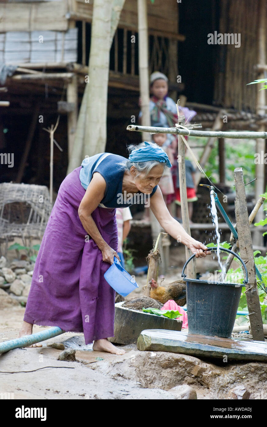 Old woman collecting water at the source, refugee camp Ei Tu Hta, IDP ...