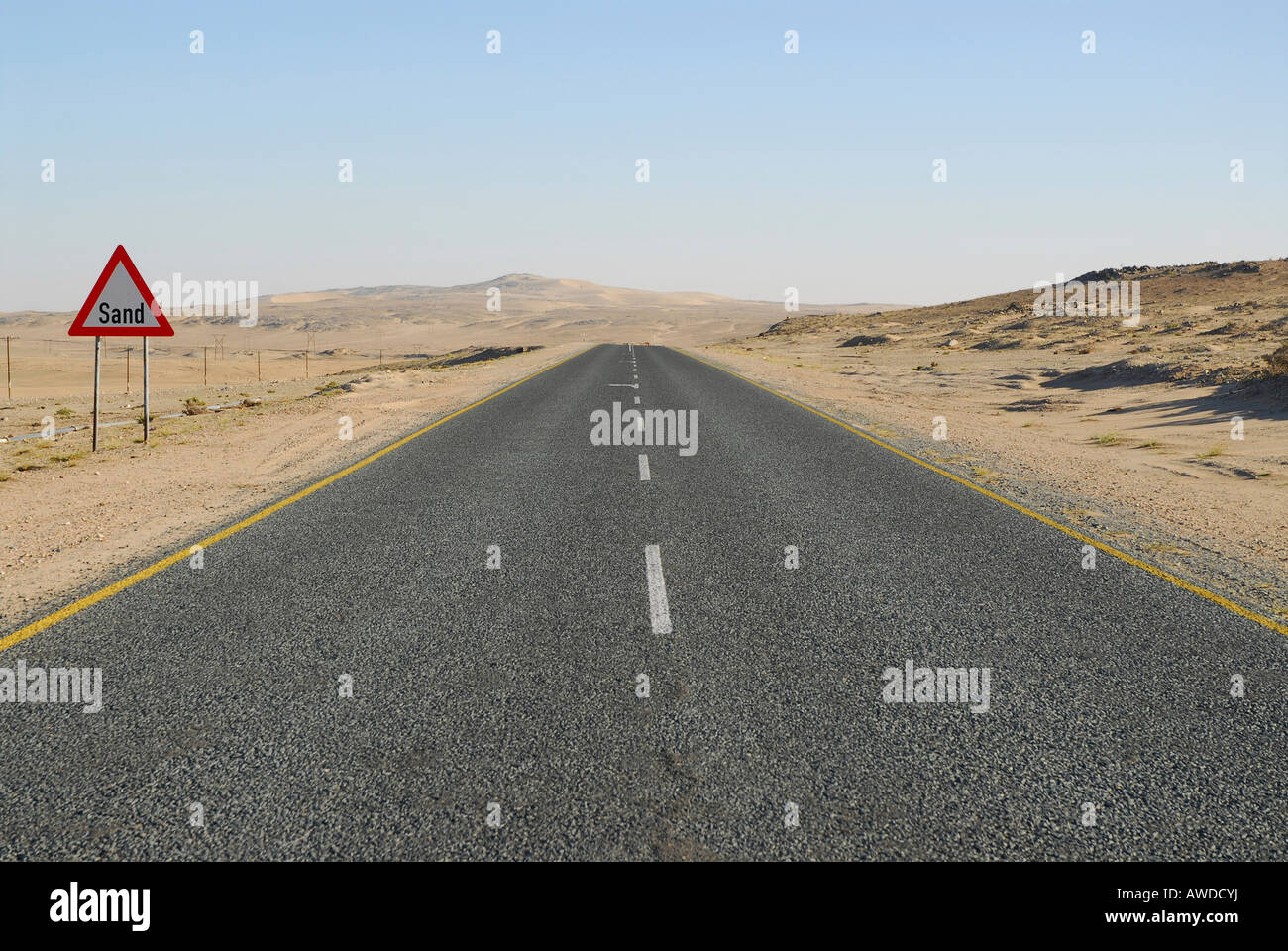 Road sign warning of sweeping sands on a highway near Luederitz ...