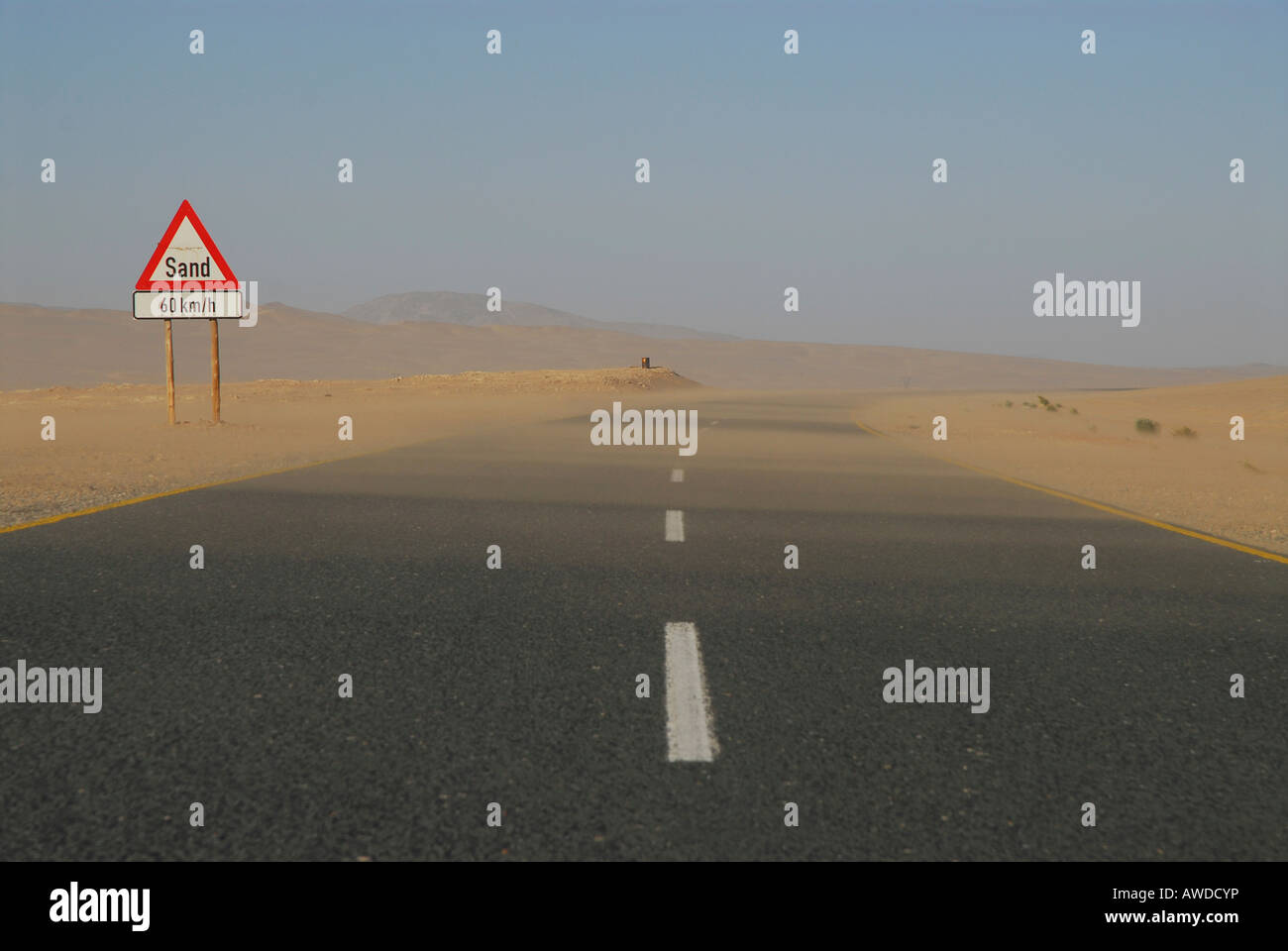Road sign warning of sweeping sands on a highway near Luederitz ...