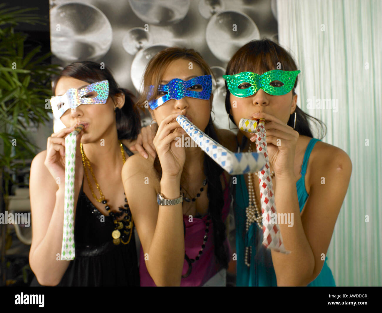 young women with party masks, having fun Stock Photo - Alamy