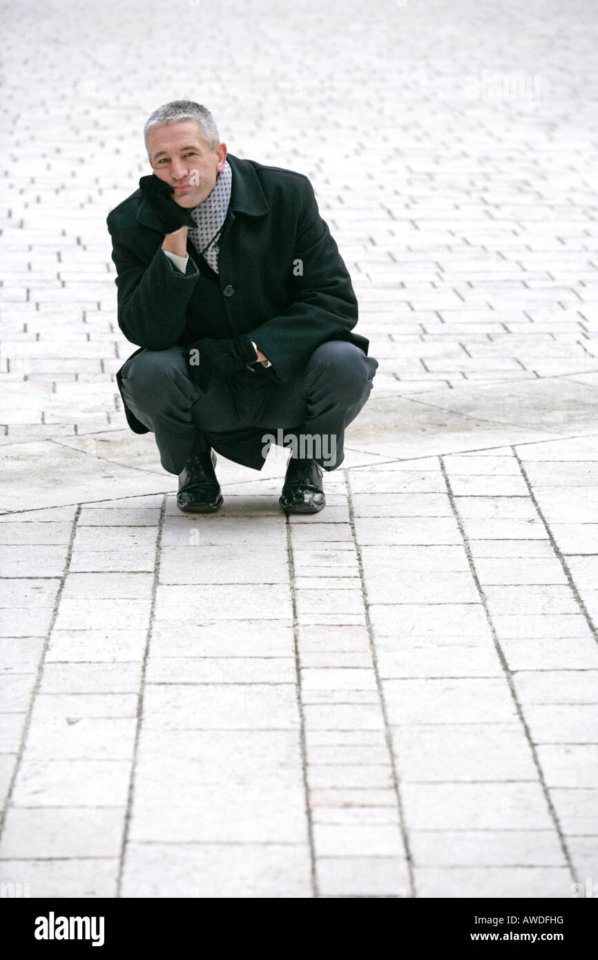 Businessman man crouching squating hi-res stock photography and images ...