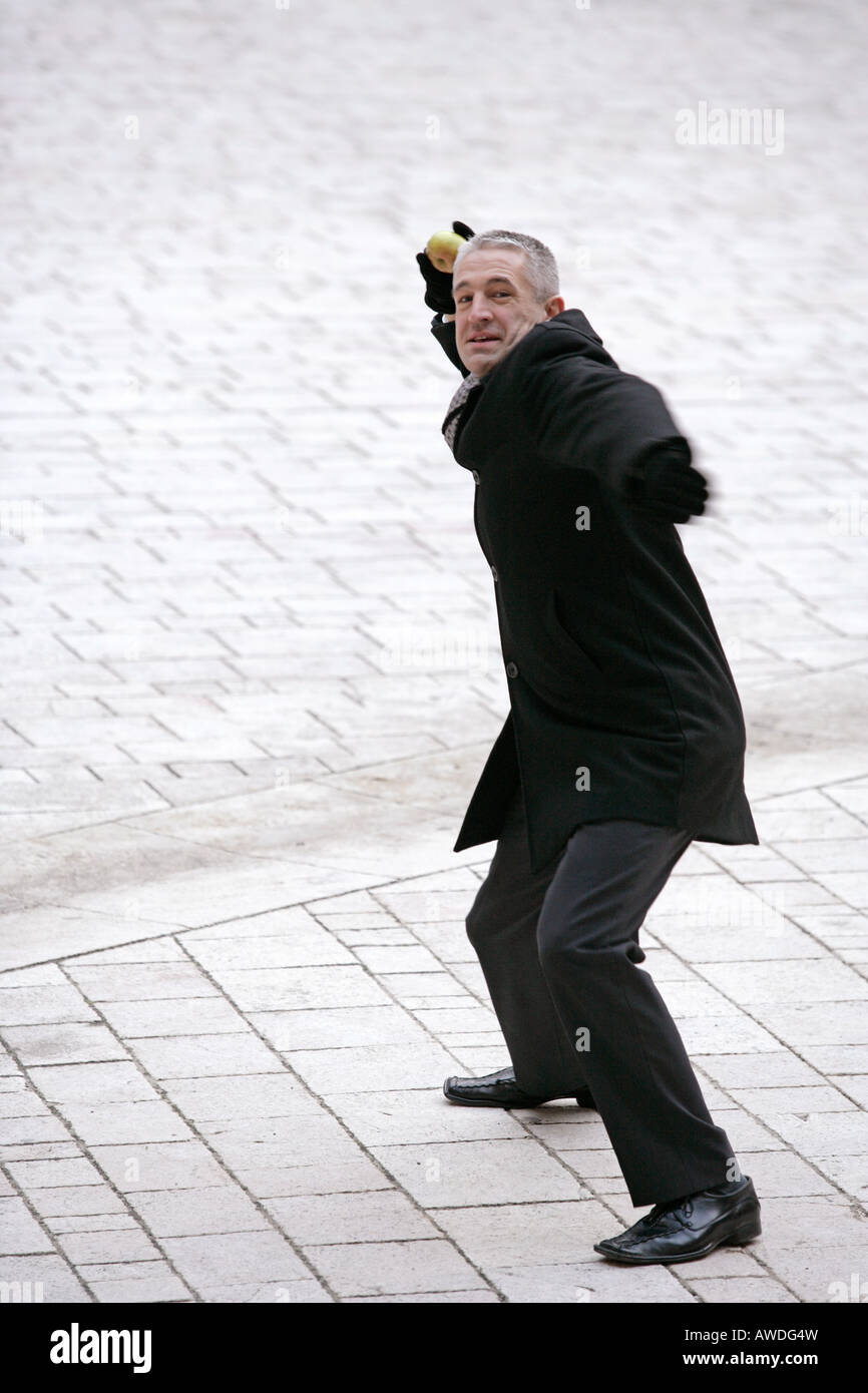 Man throwing apple Stock Photo - Alamy