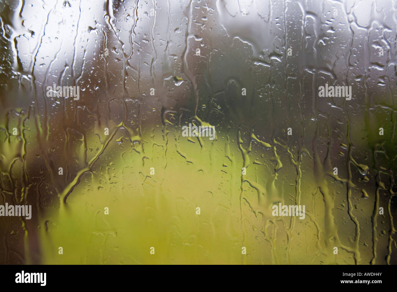 View through window with rain drops of water on pane outside during bad ...