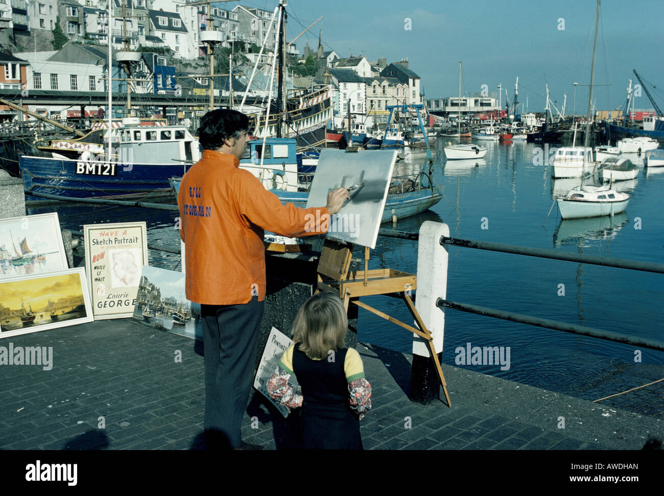 Painter on the quayside at Brixham in Devon Stock Photo - Alamy