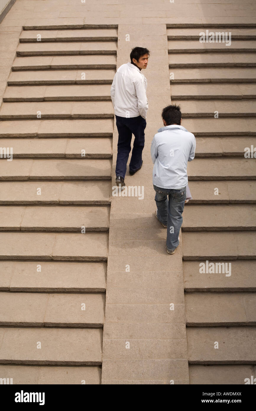 Pedestrians walk up some steps. Beijing, People's Republic of China ...