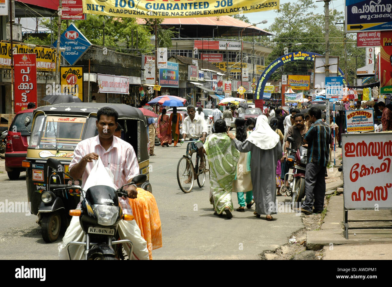 Busy street scene with transport and people walking in the road ...