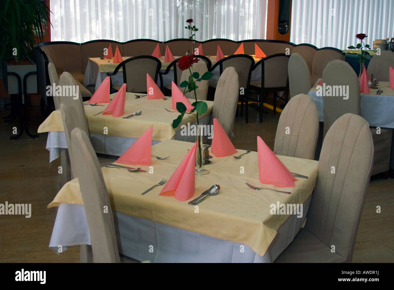 Tables setup for dinner in a hotel Stock Photo - Alamy