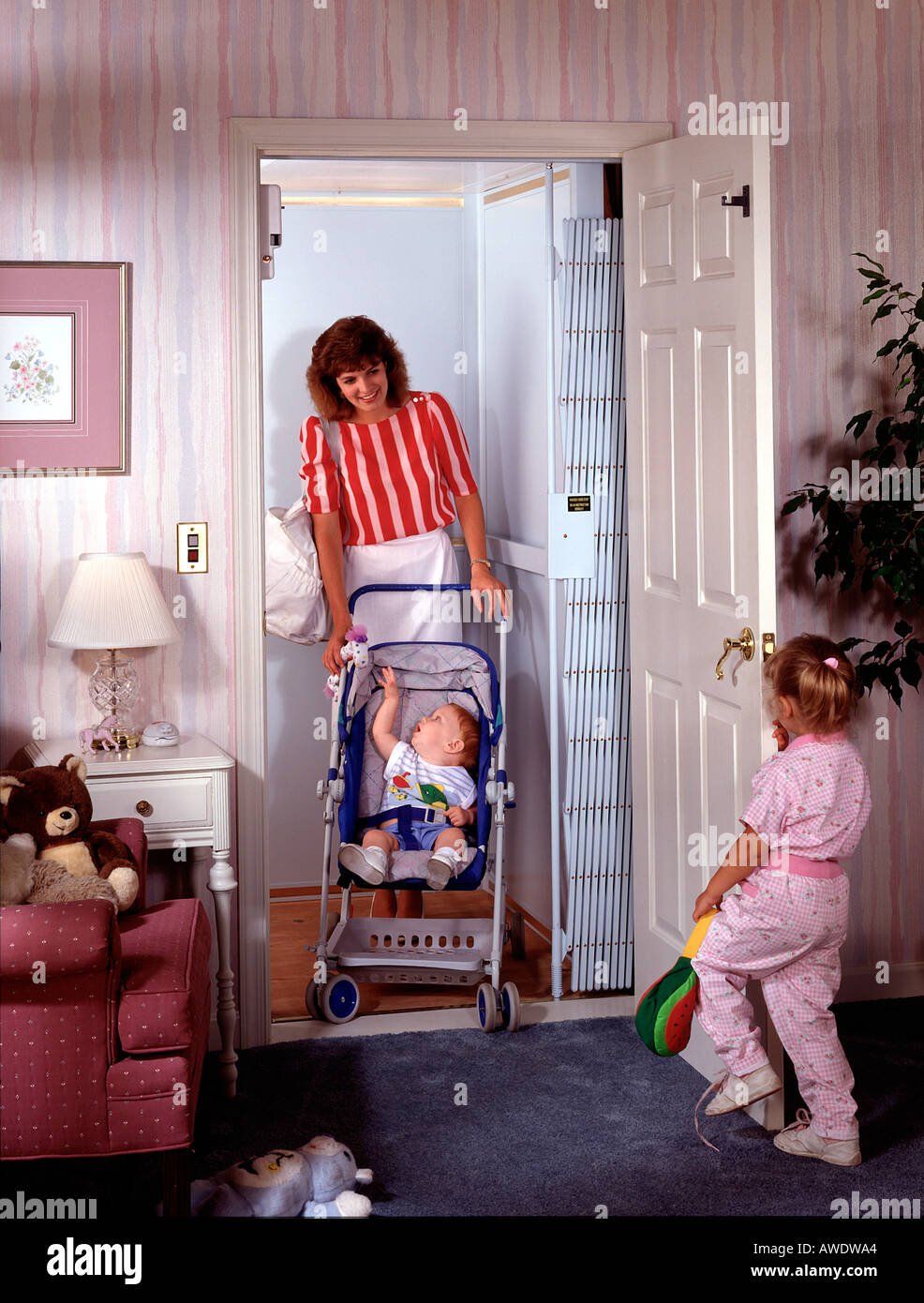 mother child baby exit enter in home elevator lift Stock Photo - Alamy